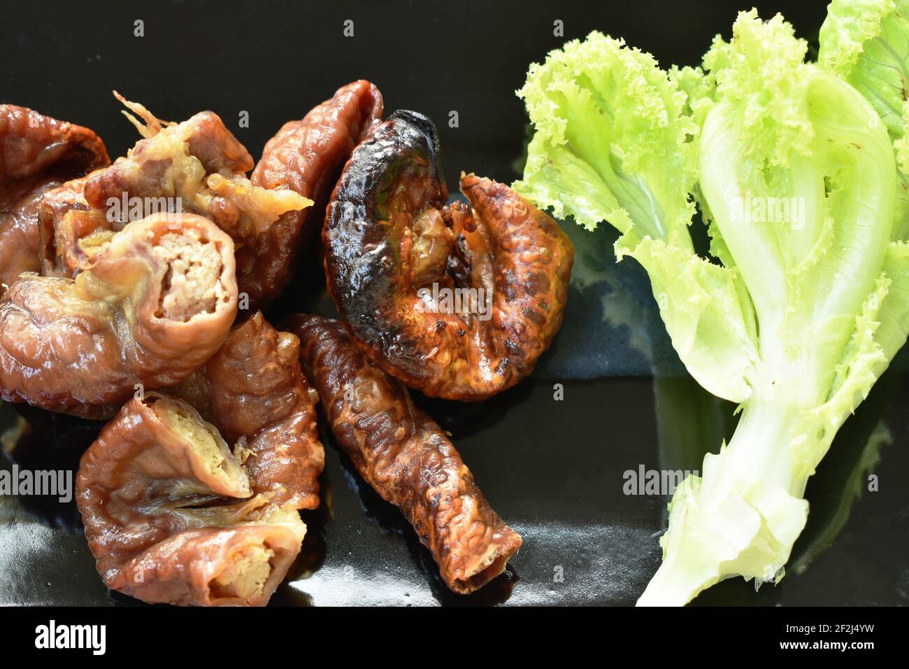roasted pork neck and innards on plate dipping with tamarind sauce ...