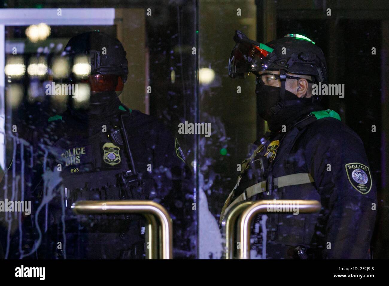 Federal Protective Service officers wait inside the Hatfield Courthouse ...
