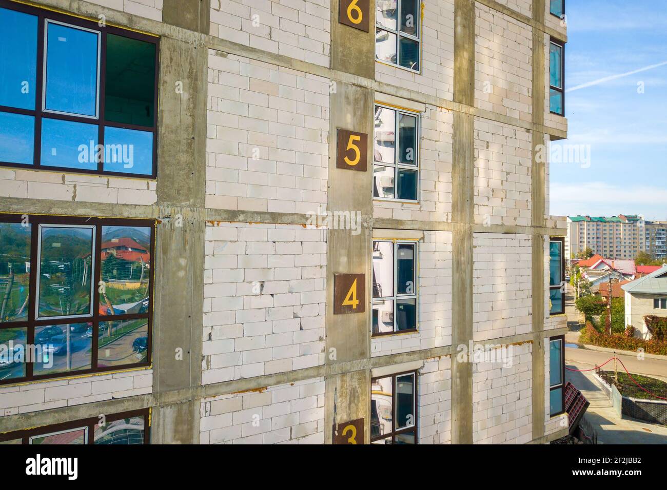 Aerial view of high residential apartment building with storey numbers ...