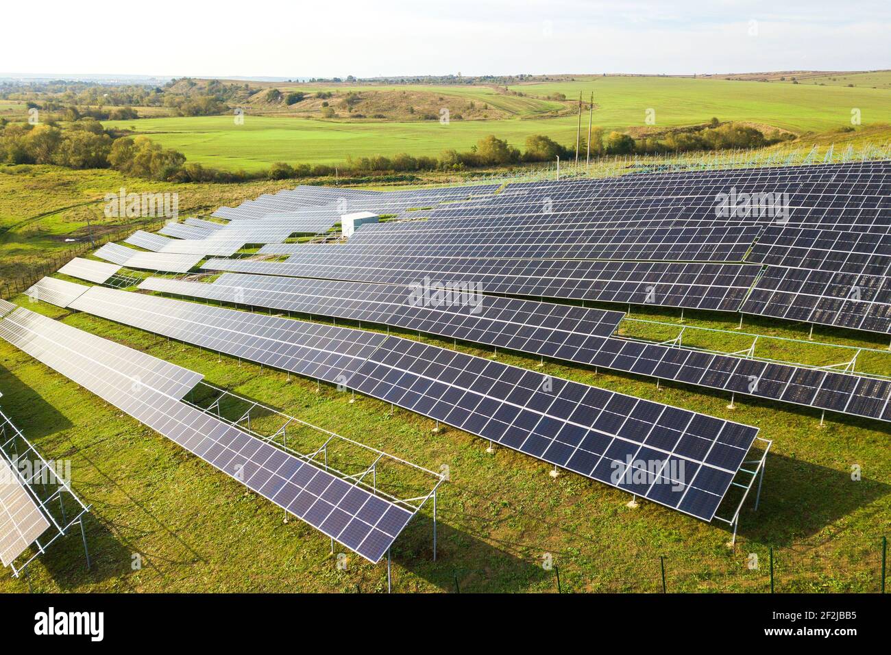 Aerial view of solar power plant under construction on green field ...