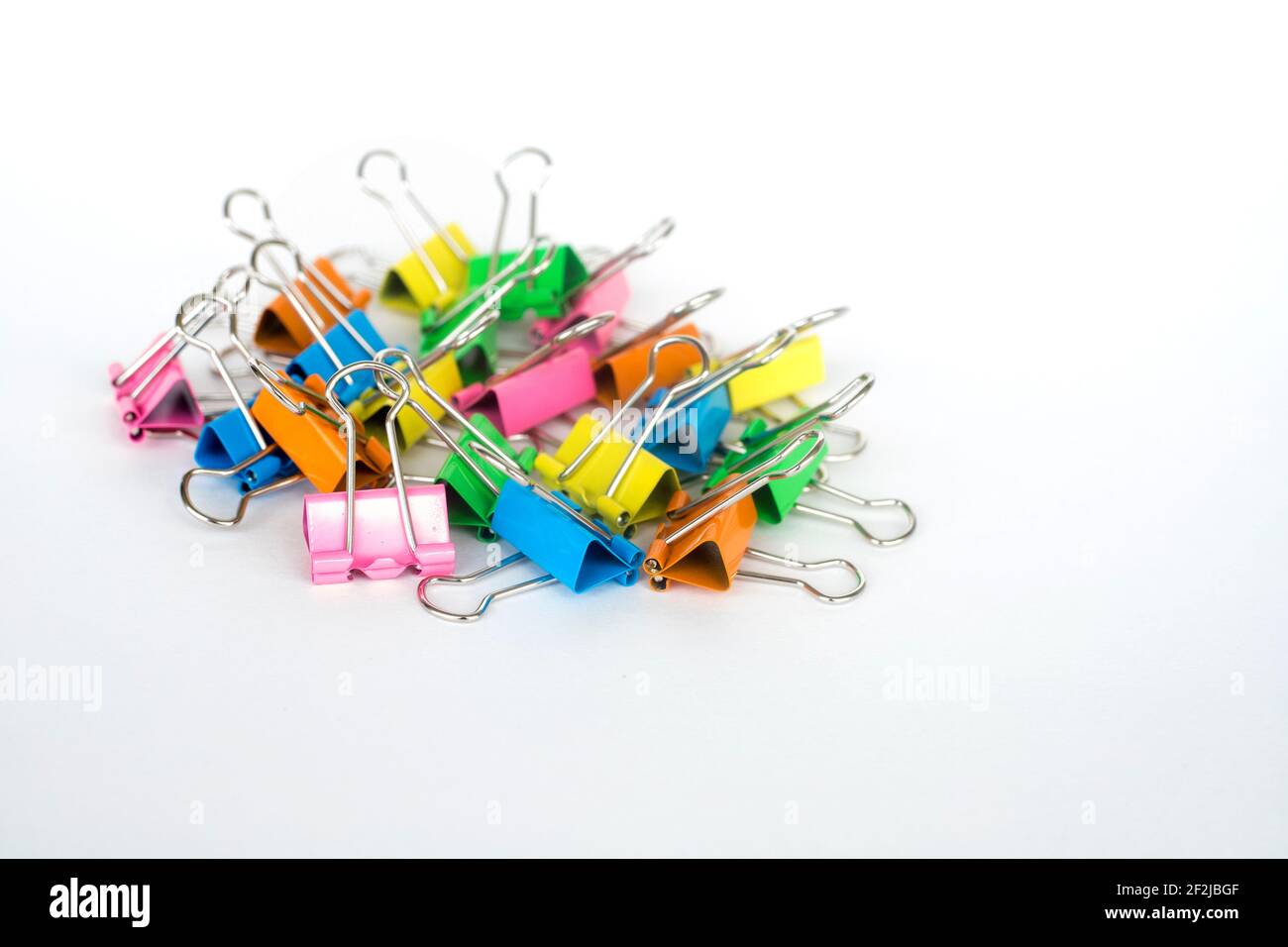 Multi color paper binder clips on white background Stock Photo - Alamy