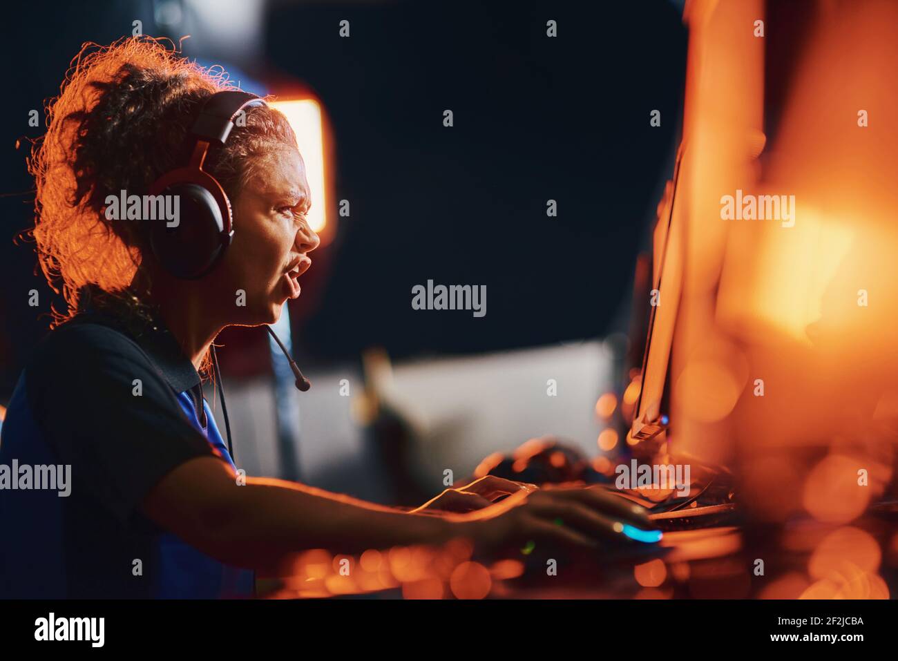 Failure. Side view of angry mixed race girl, female cybersport gamer ...