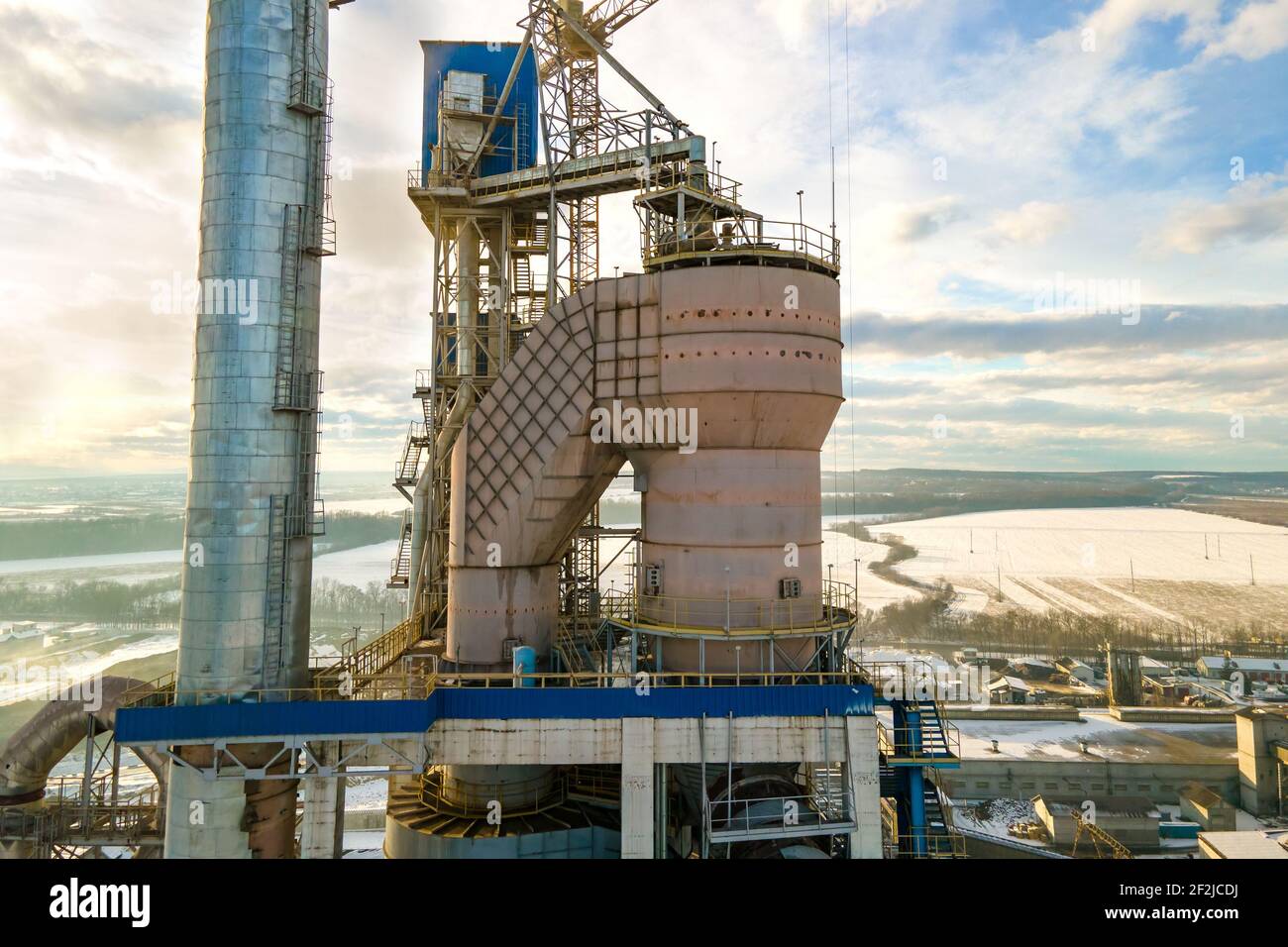 Aerial view of cement plant with high factory structure and tower crane ...