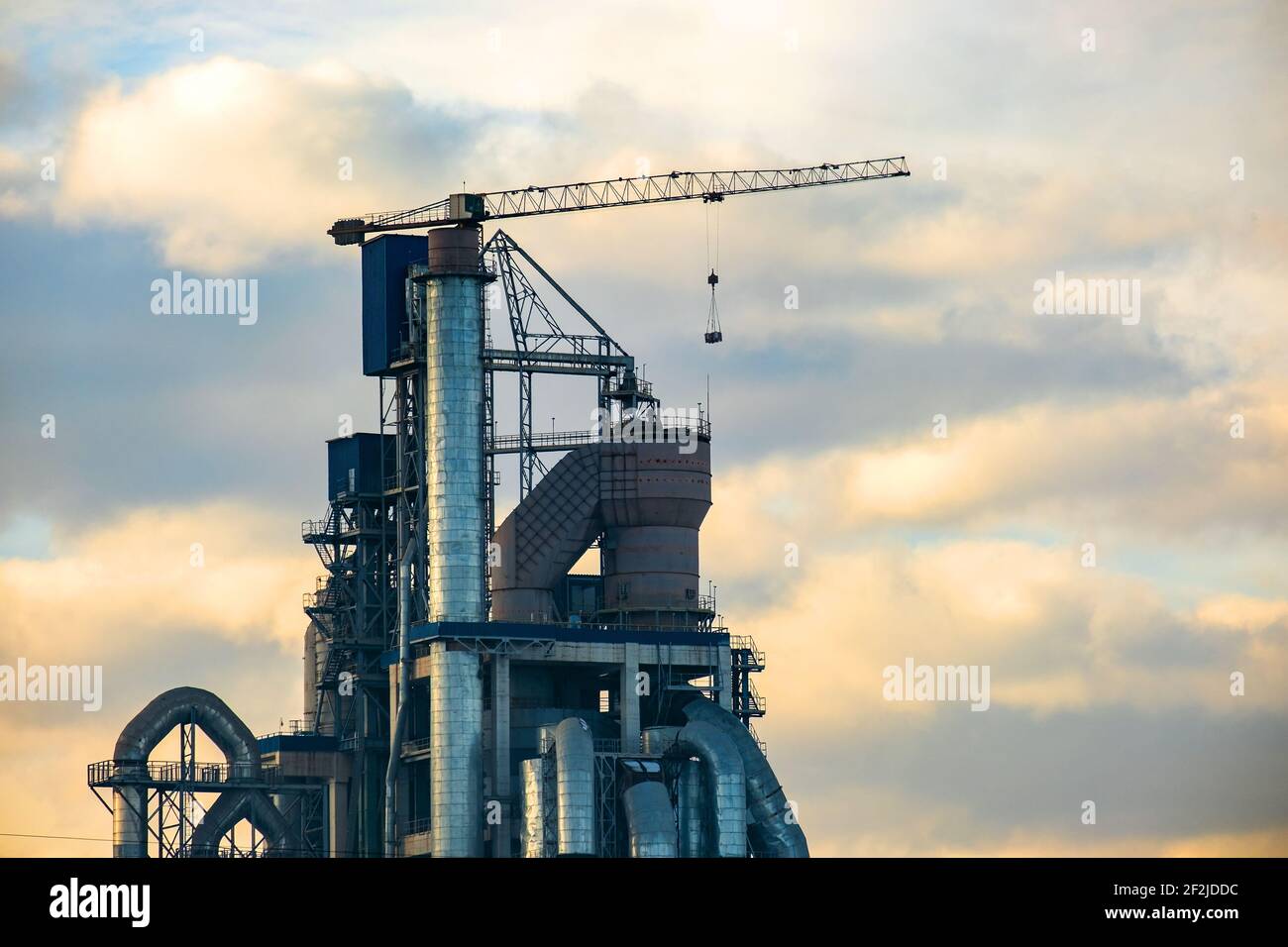 Cement plant with high factory structure and tower crane at industrial ...