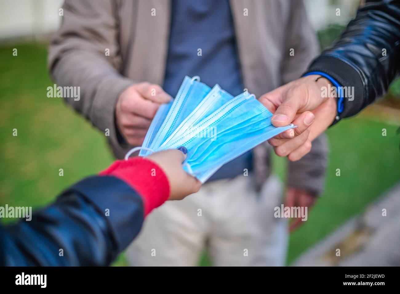 Sharing makes us happy - Female is sharing medical face mask with to ...
