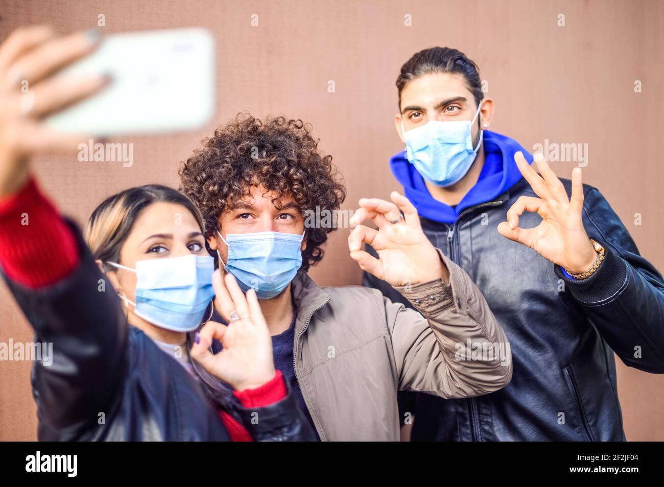 Self portrait of happy positive friends shooting selfie on front camera ...