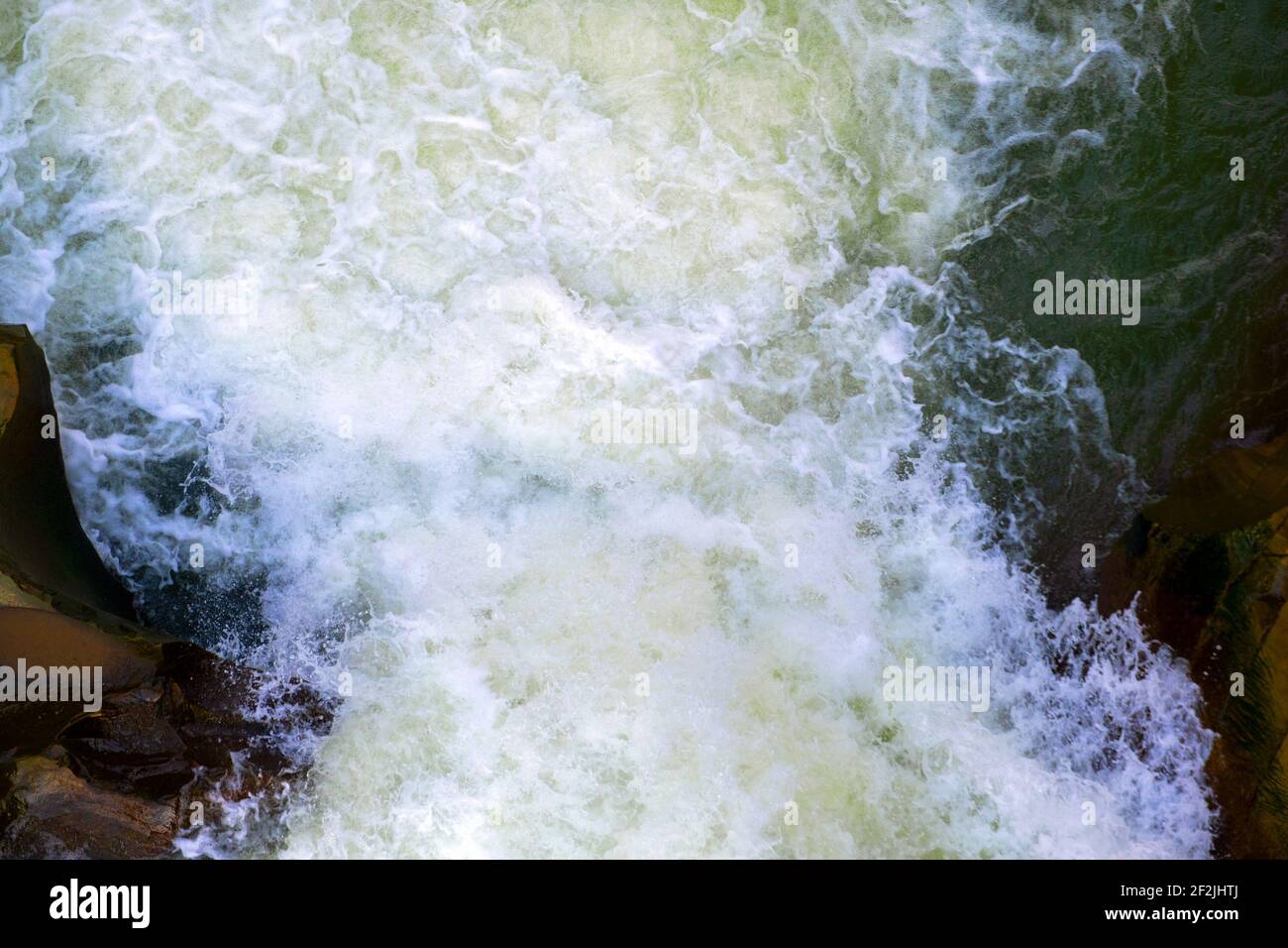 Aerial view of river waterfall with clear turquoise water falling down ...