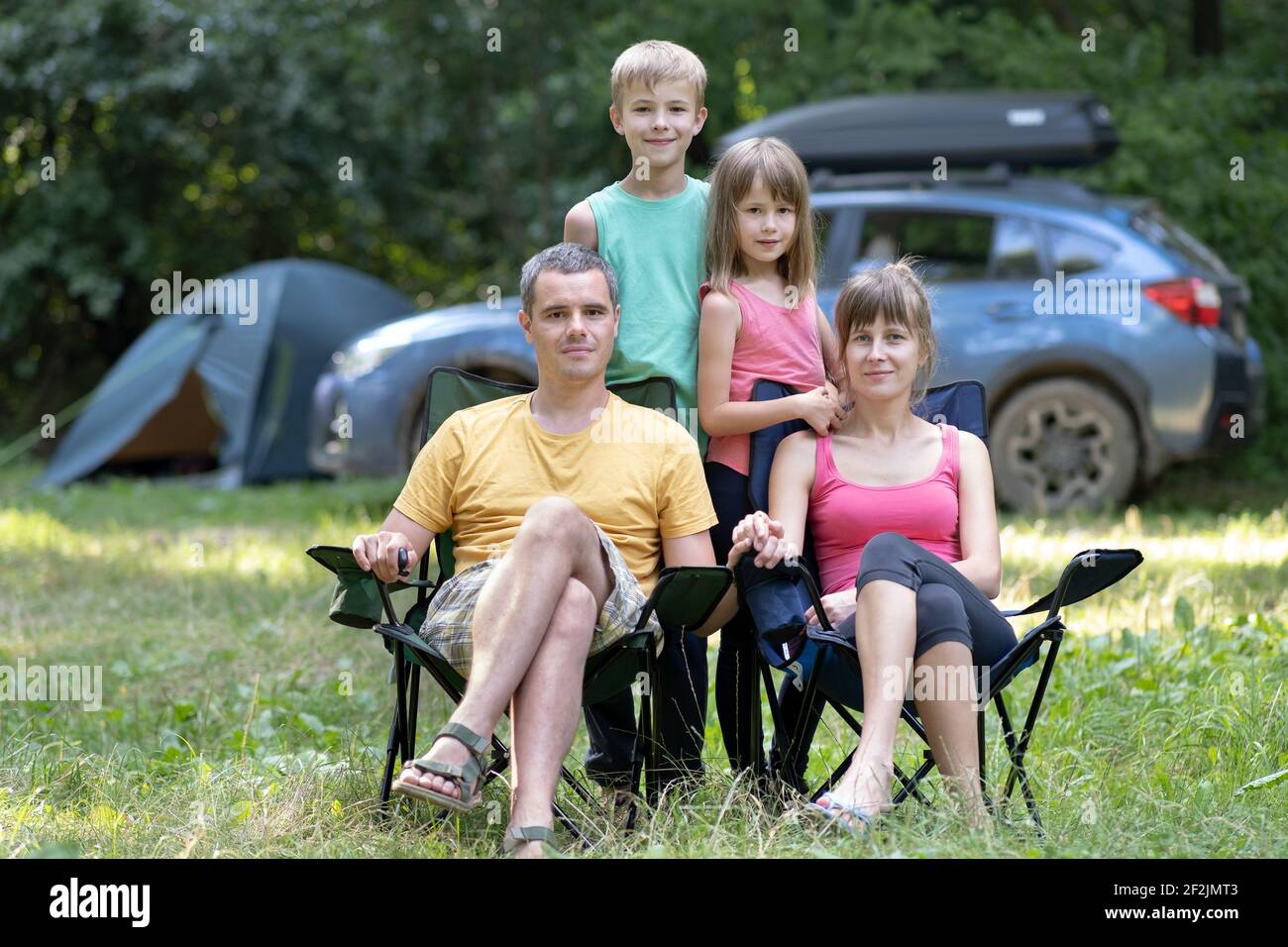 Happy family four camping hi-res stock photography and images - Alamy