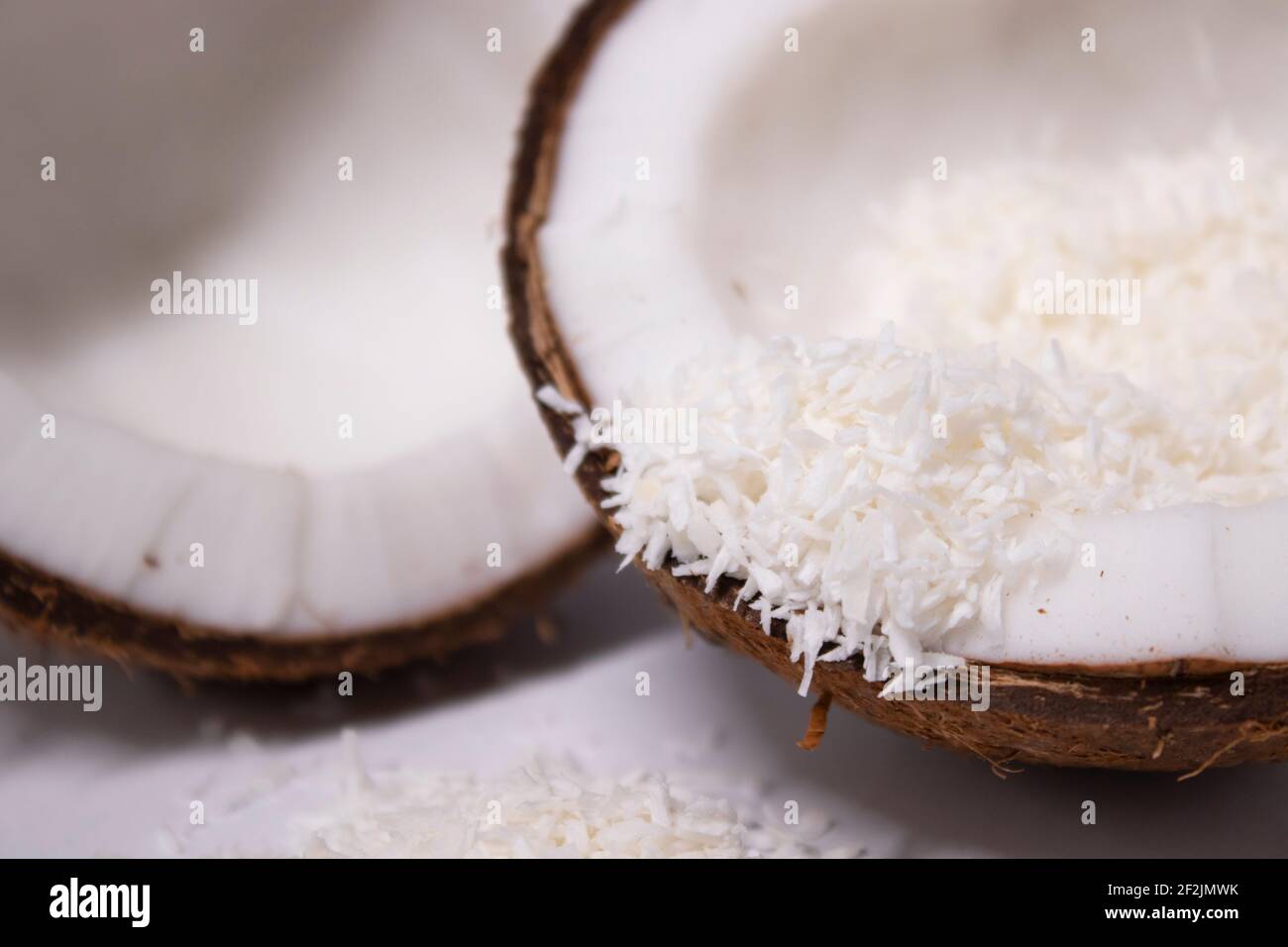 opened coconut with coconut flakes isolated on white background ...