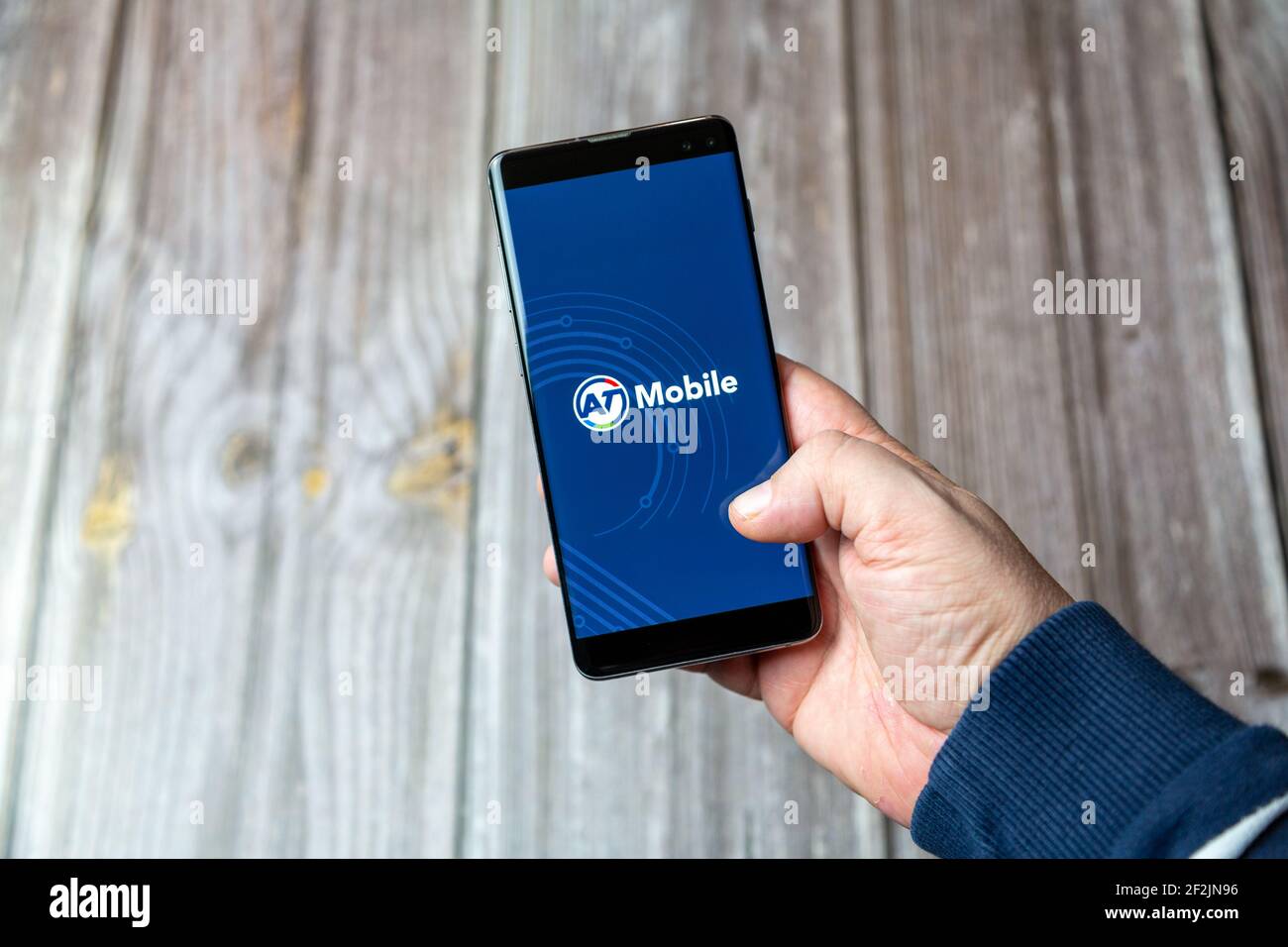 A Mobile phone or cell phone being held in a hand with the AT Mobile ...