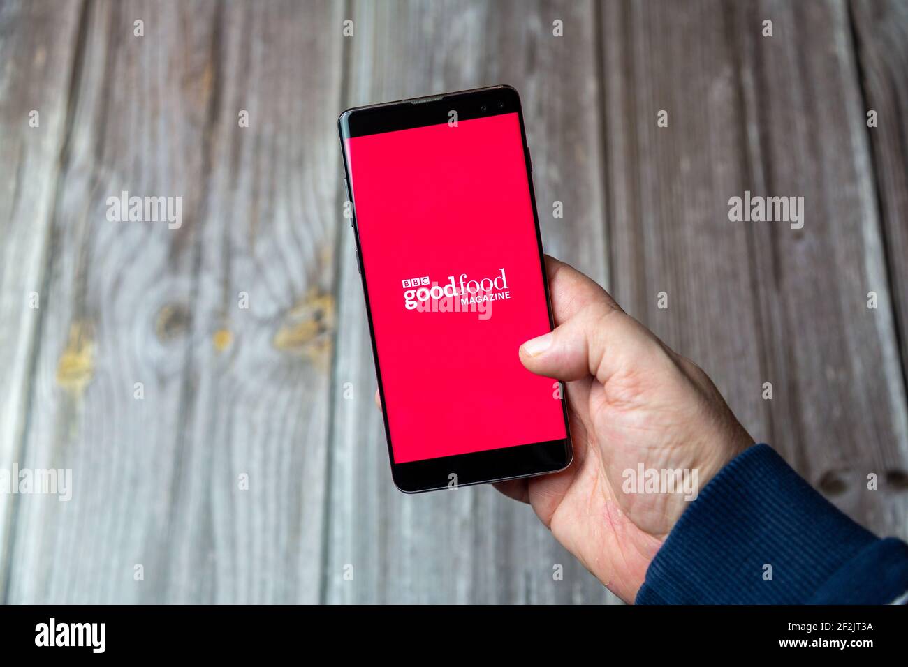 A Mobile phone or cell phone being held in a hand with the BBC Good ...