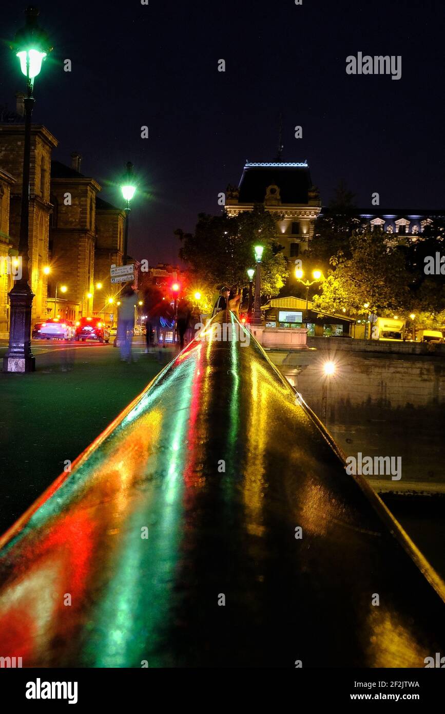 Colorful reflections on a bridge at night in Paris France Stock Photo ...
