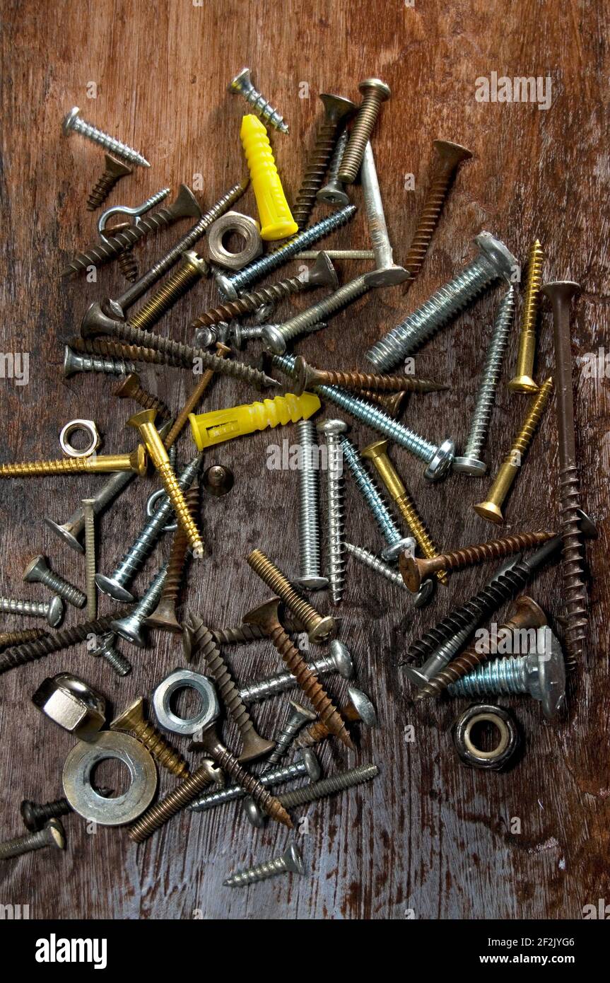 Old Dusty Rusted Nuts, Bolts and Screws on Rustic Wood Vertical Stock ...
