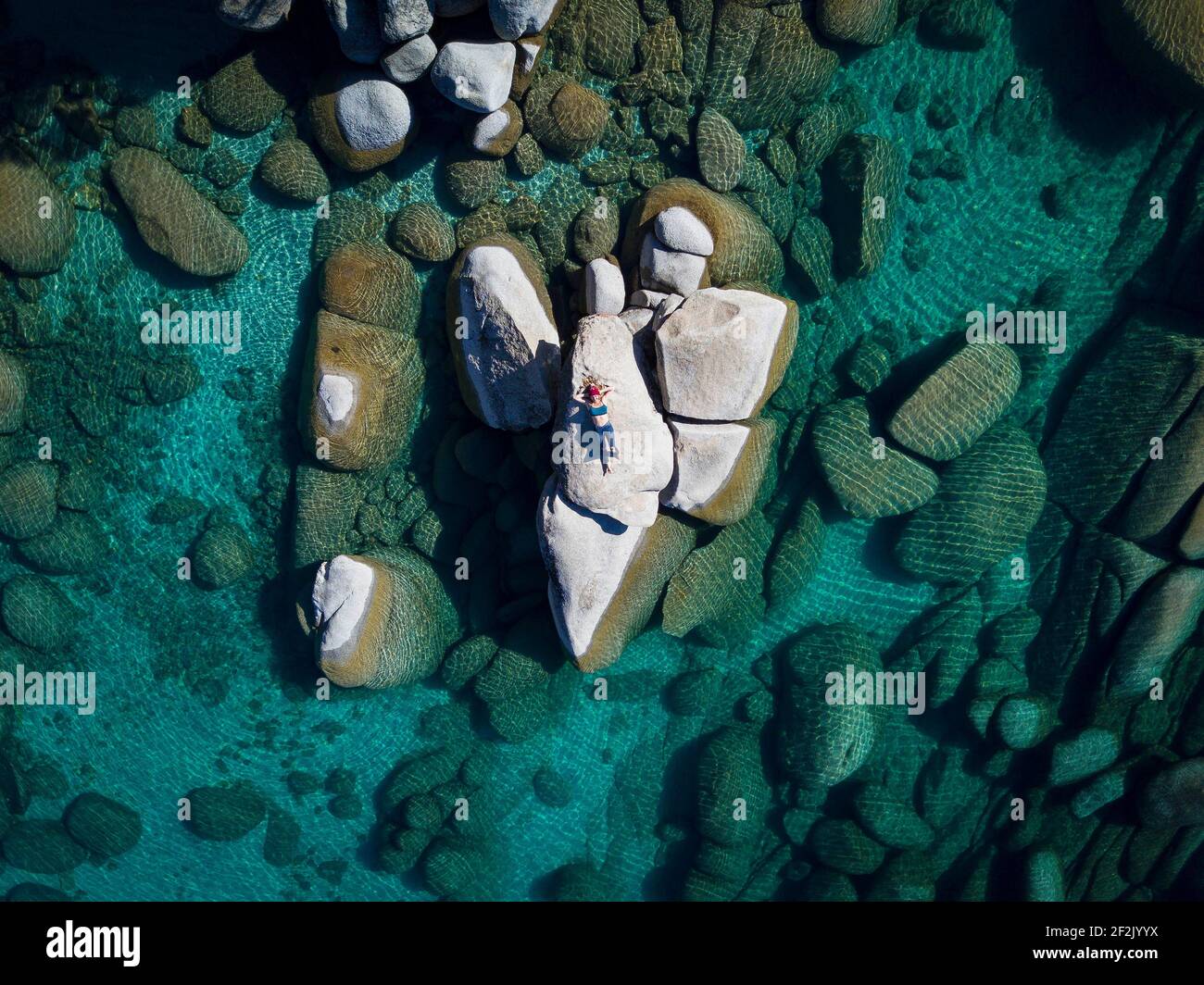 aerial view female laying on rock in lake tahoe Stock Photo - Alamy