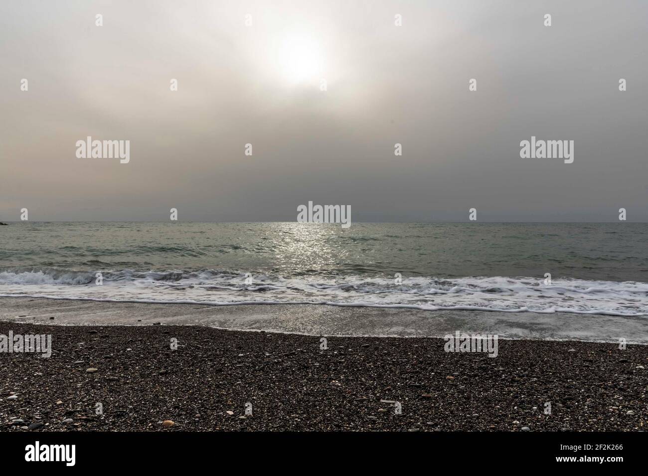 Sunset over the sea with haze Stock Photo - Alamy