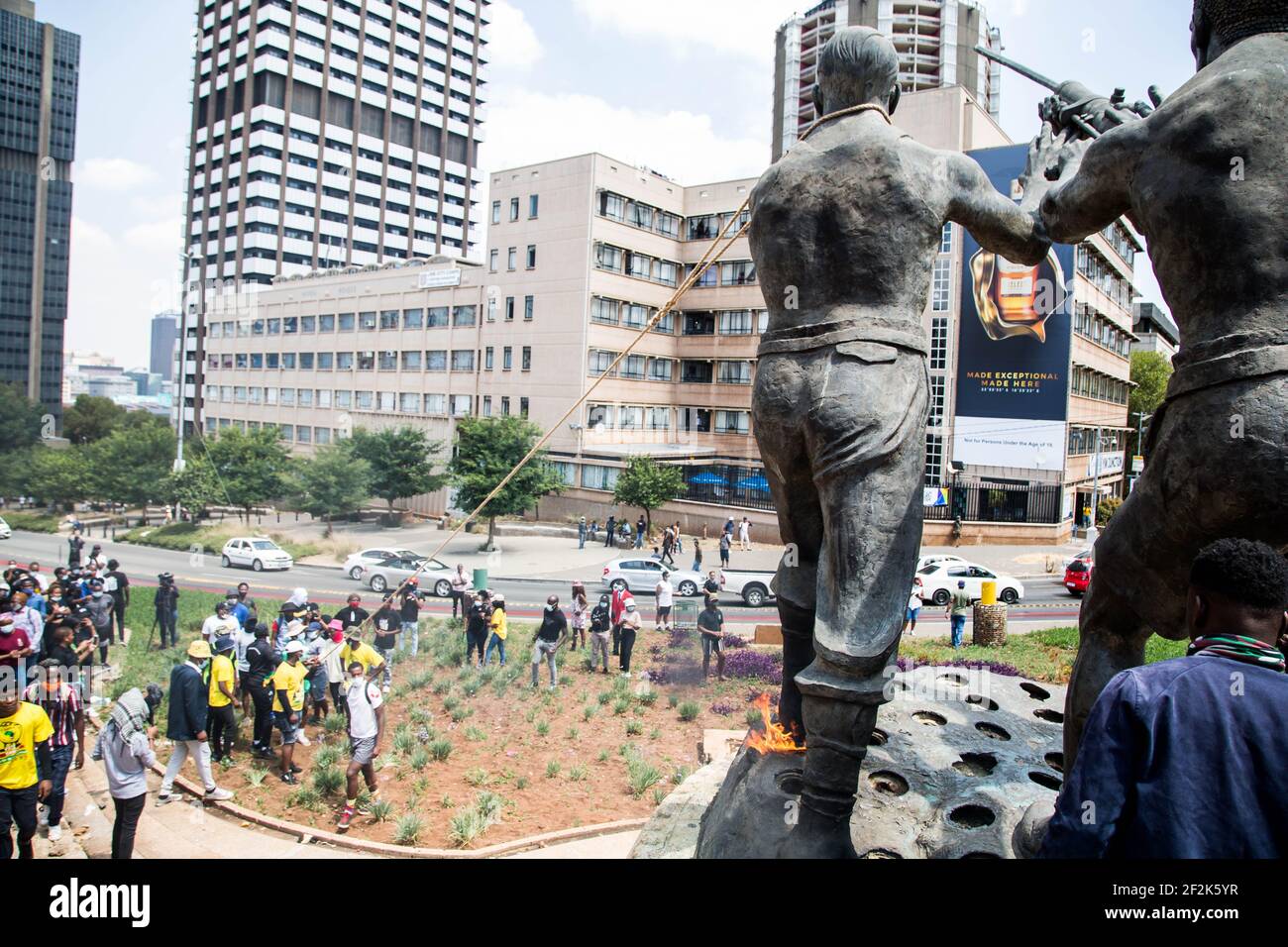 Students attempt to topple a colonial statue during the demonstration ...