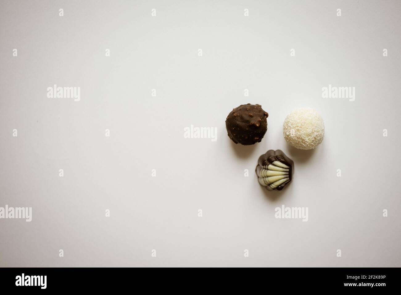 three chocolate candies on a white background Stock Photo - Alamy