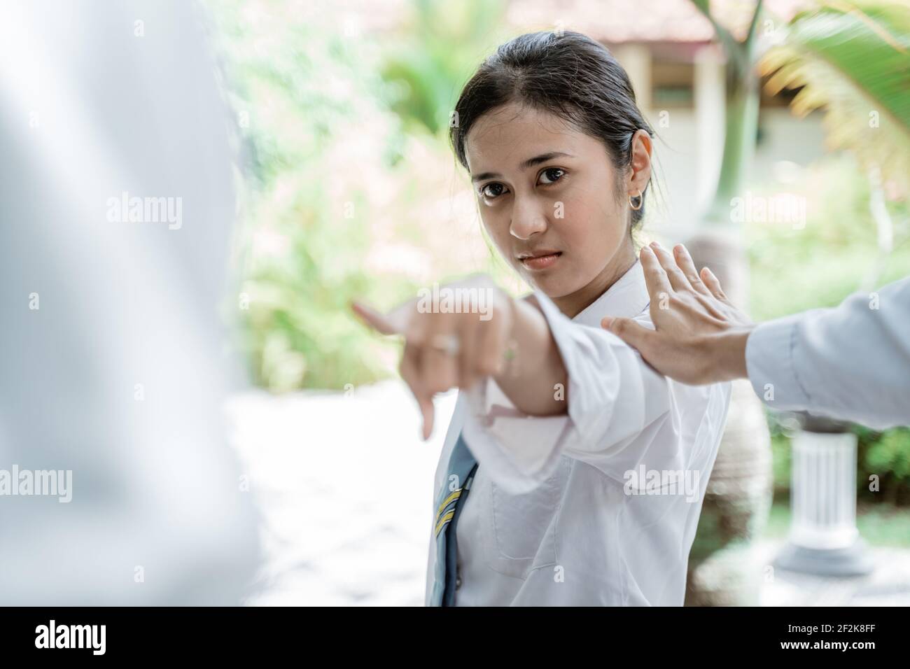 close up of a female high school student in Indonesia angry with finger ...