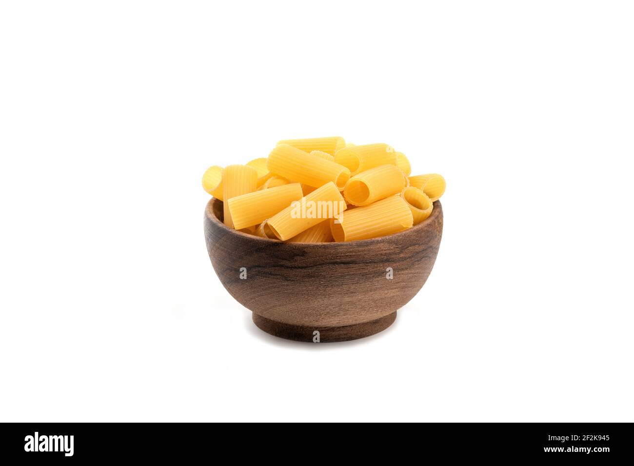 Wooden bowl of raw tube pasta isolated on white background Stock Photo ...