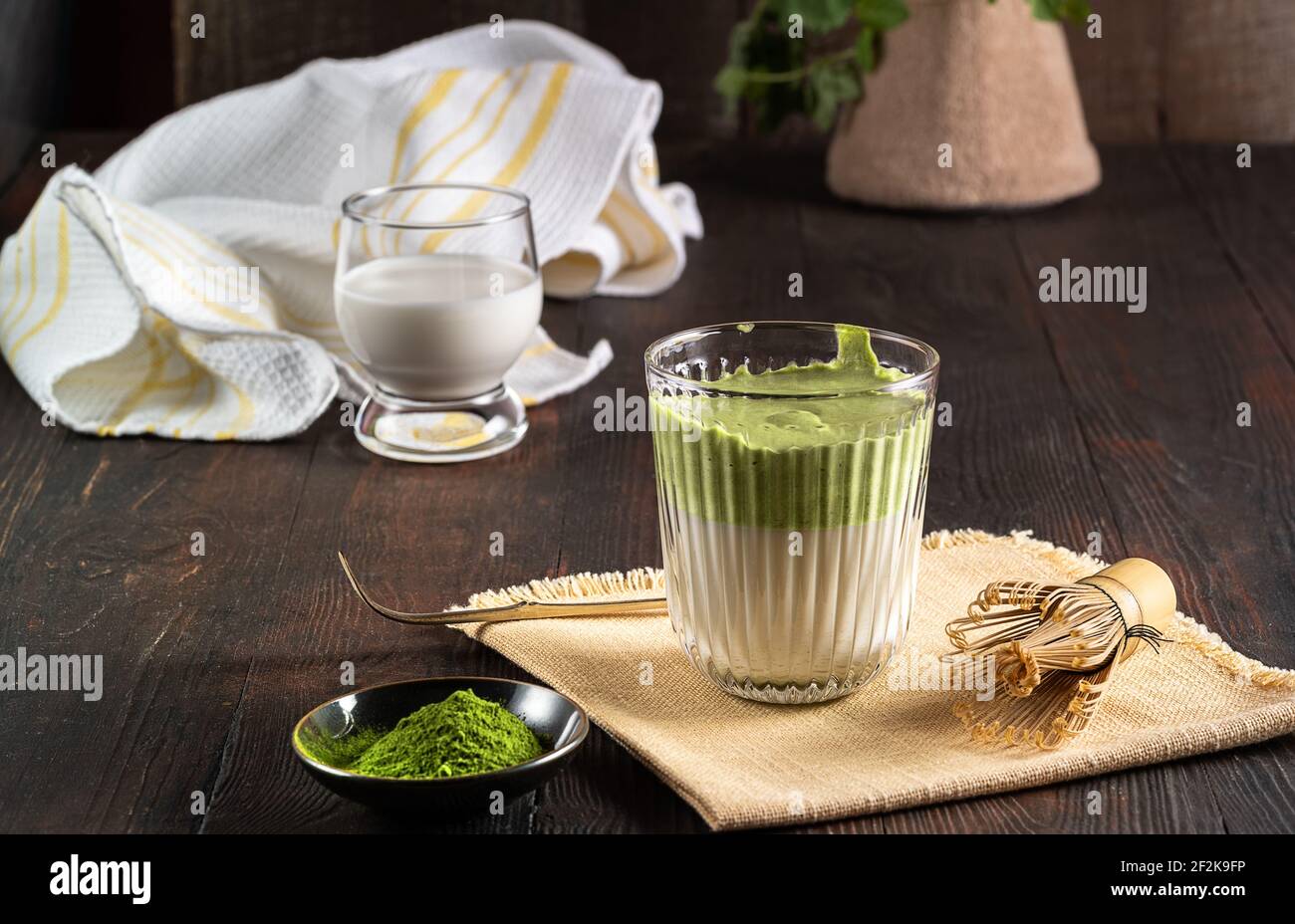 Matcha green latte tea, matcha powder and bamboo whisk on wood ...