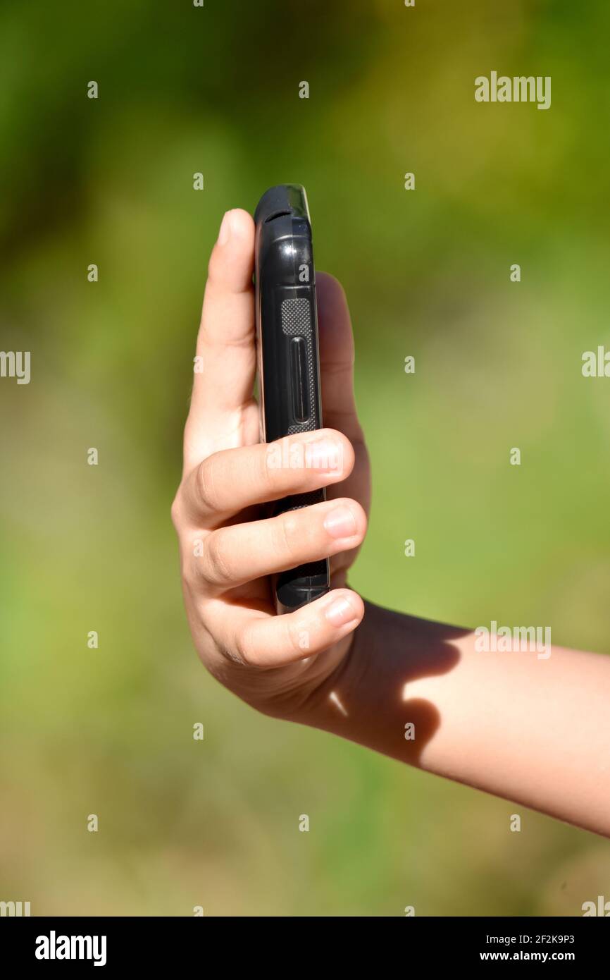 A Child Hand Holding Cell Phone Stock Photo - Alamy