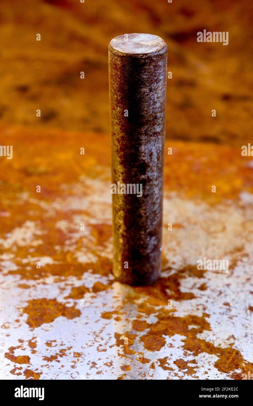 Cylindrical piece of metal putted on a rusted metal plate, Illustration ...