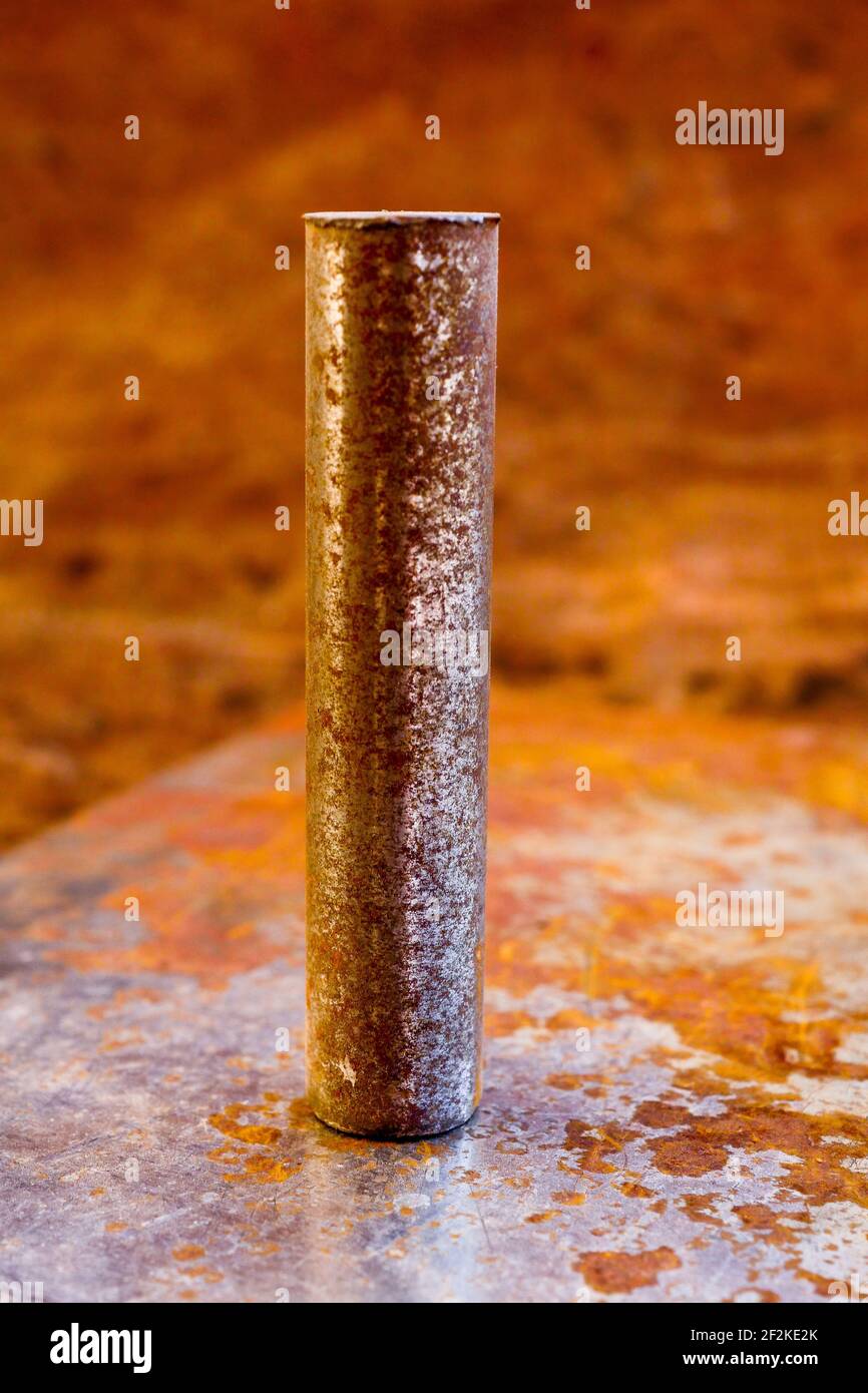 Cylindrical piece of metal putted on a rusted metal plate, Illustration ...