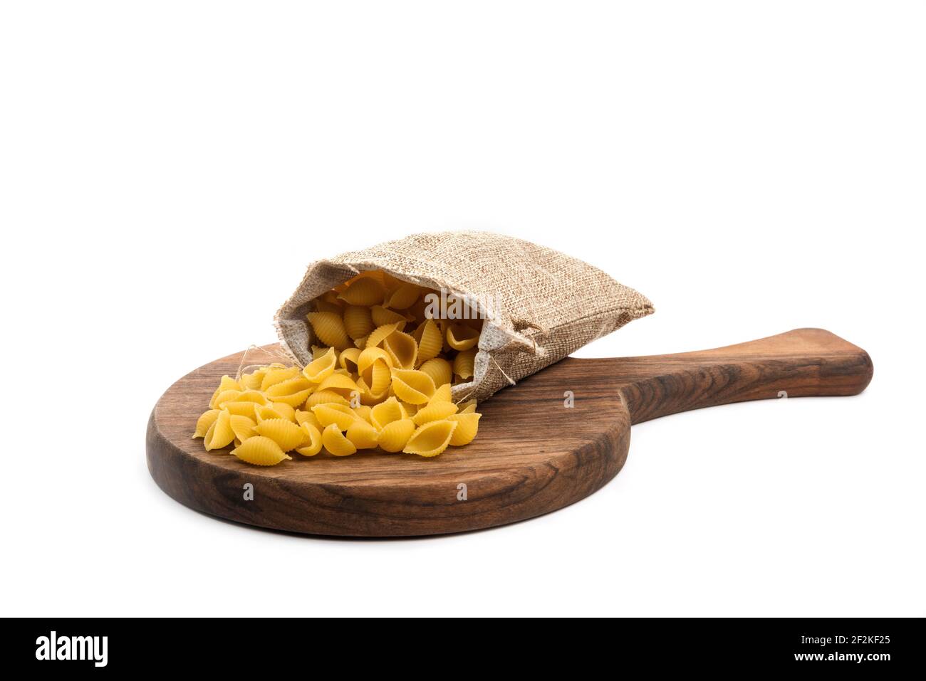 Conchiglie rigate pasta or seashell macaroni in sack isolated Stock ...