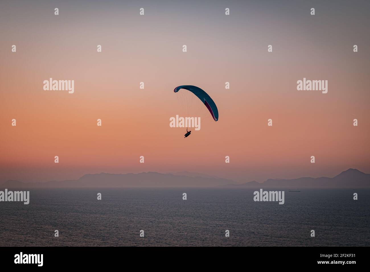 Amazing paragliding in sunset Stock Photo - Alamy