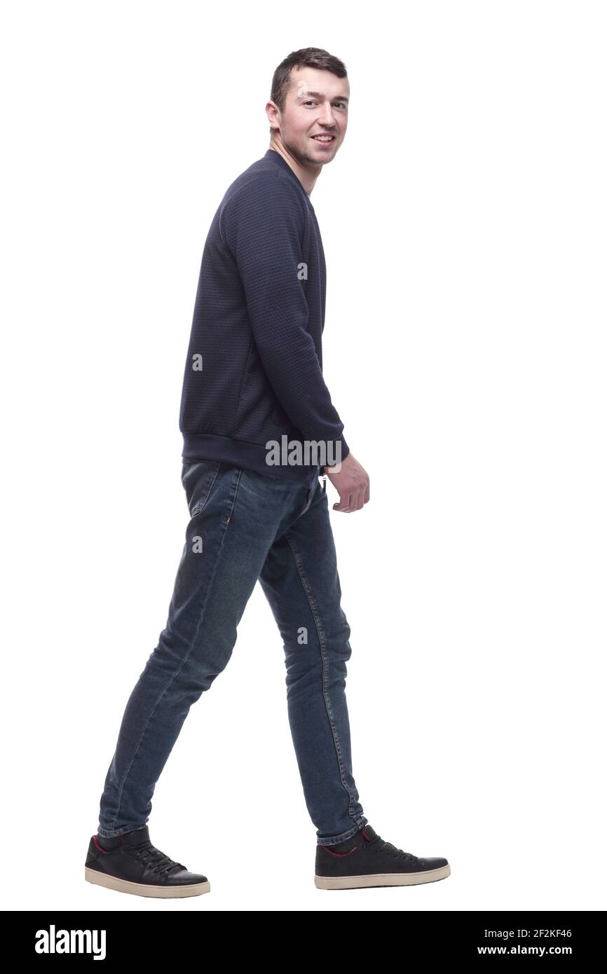 young man in jeans striding forward . isolated on a white Stock Photo ...