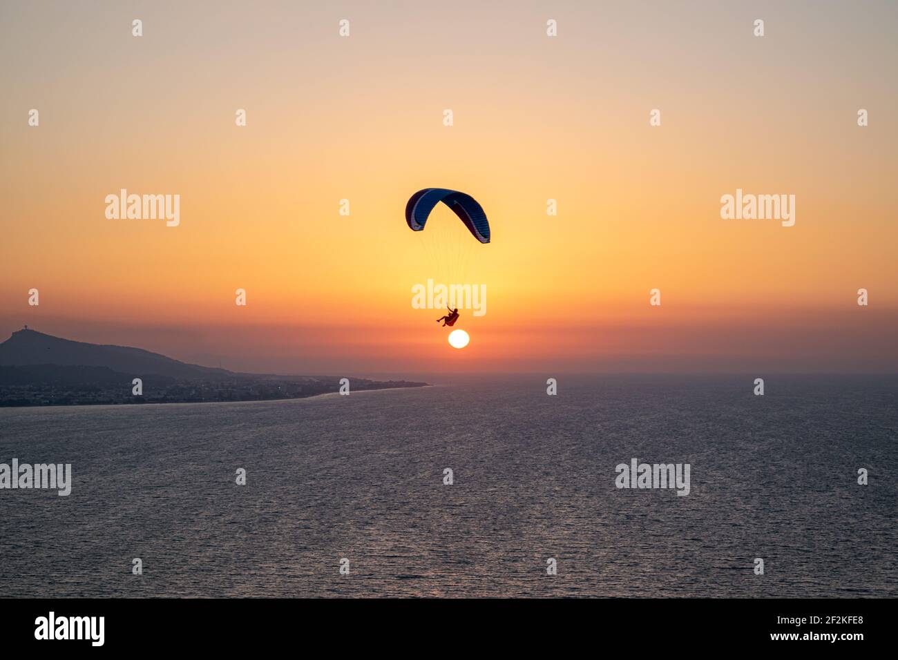 Amazing paragliding in sunset Stock Photo - Alamy