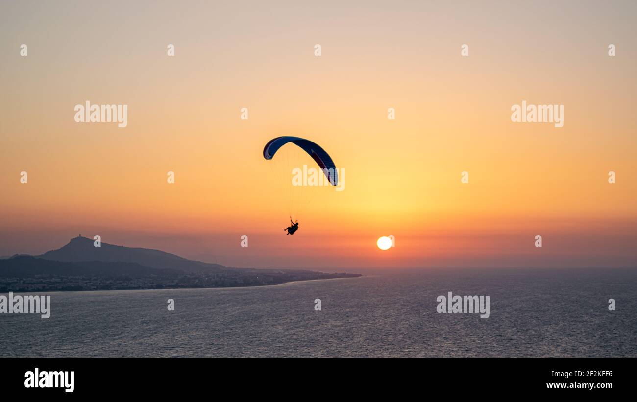 Amazing paragliding in sunset Stock Photo - Alamy