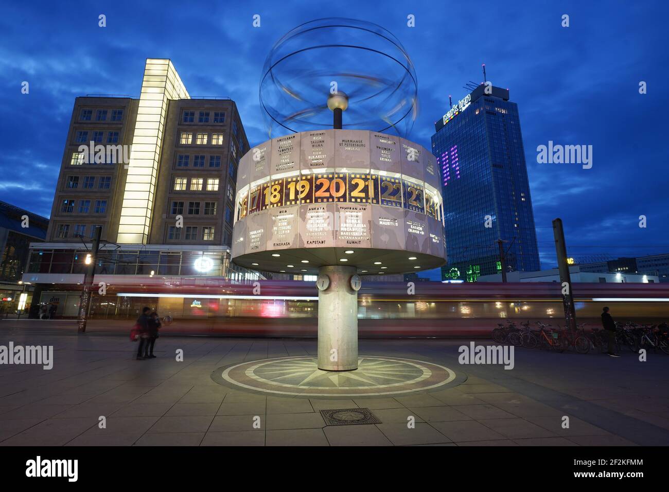 Berlin, Germany. 12th Mar, 2021. The world time clock on Alexanderplatz is illuminated at dusk ...