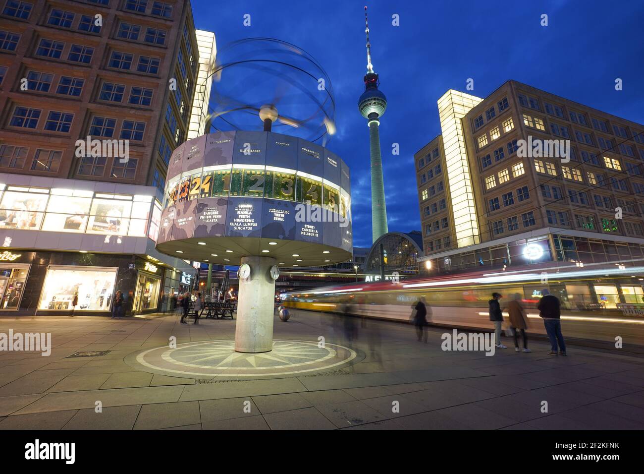 Berlin, Germany. 12th Mar, 2021. The world time clock on Alexanderplatz is illuminated at dusk ...
