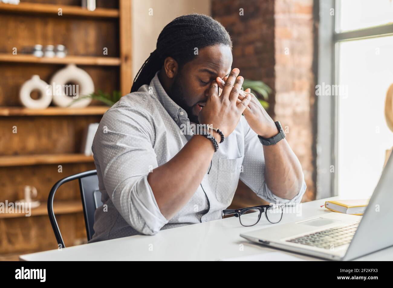 Frustrated african-american businessman worrying about project, sitting ...