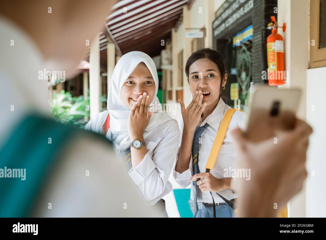 Two female high school students with shocked expressions when a student ...