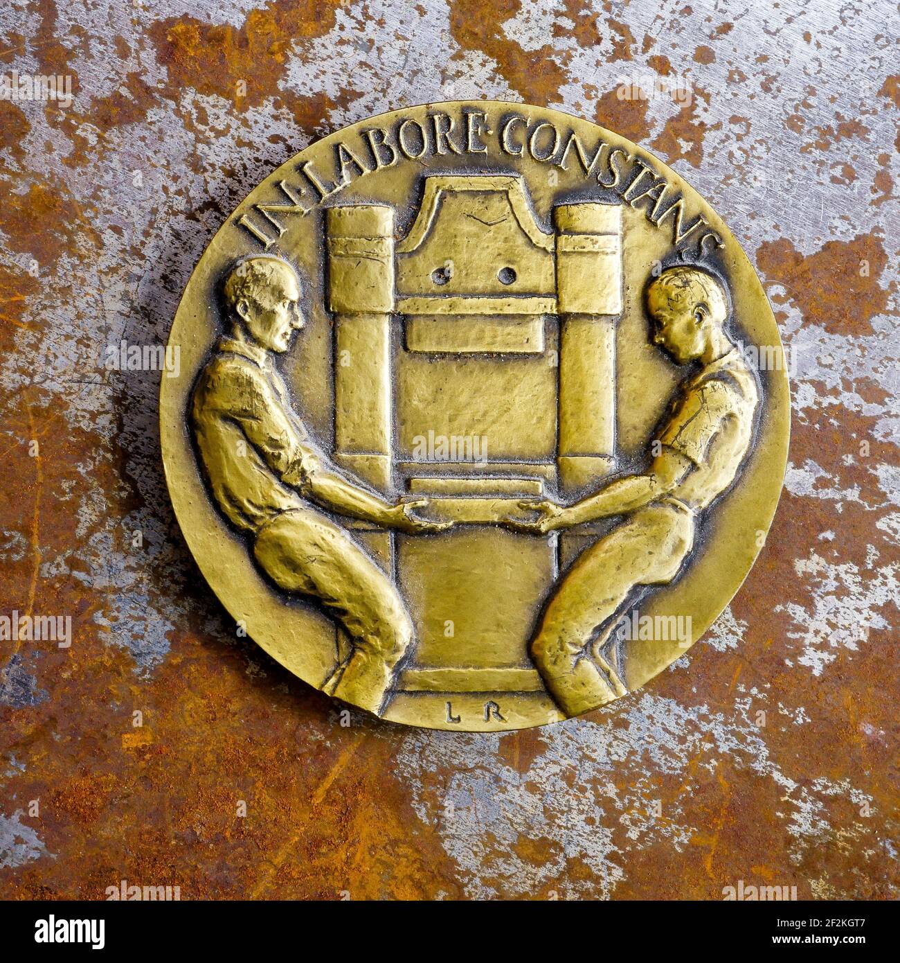 Bronze medal, with two workers and the words "Hard workers ...