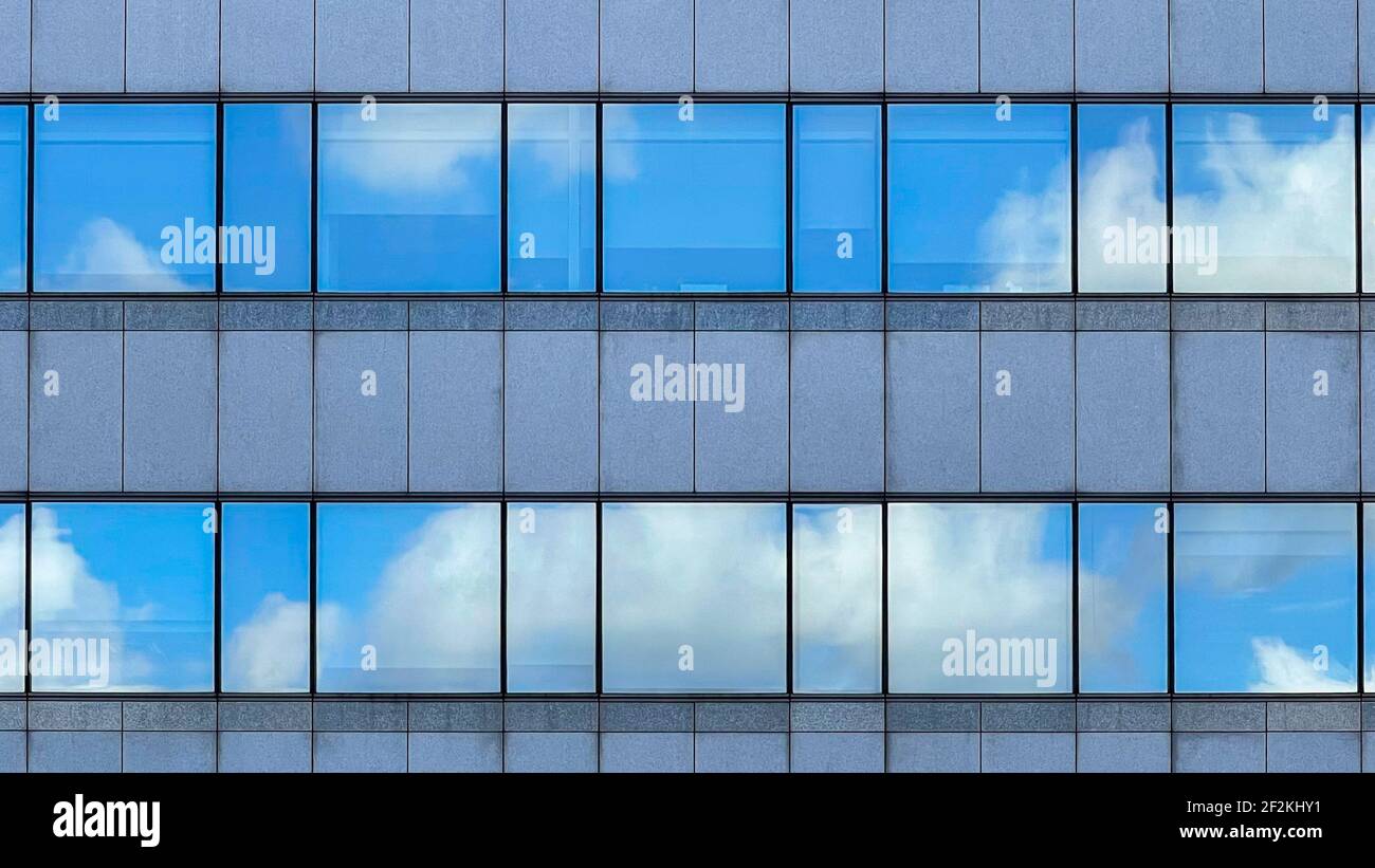 Beautiful and modern tall tower with clouds in the financial district ...