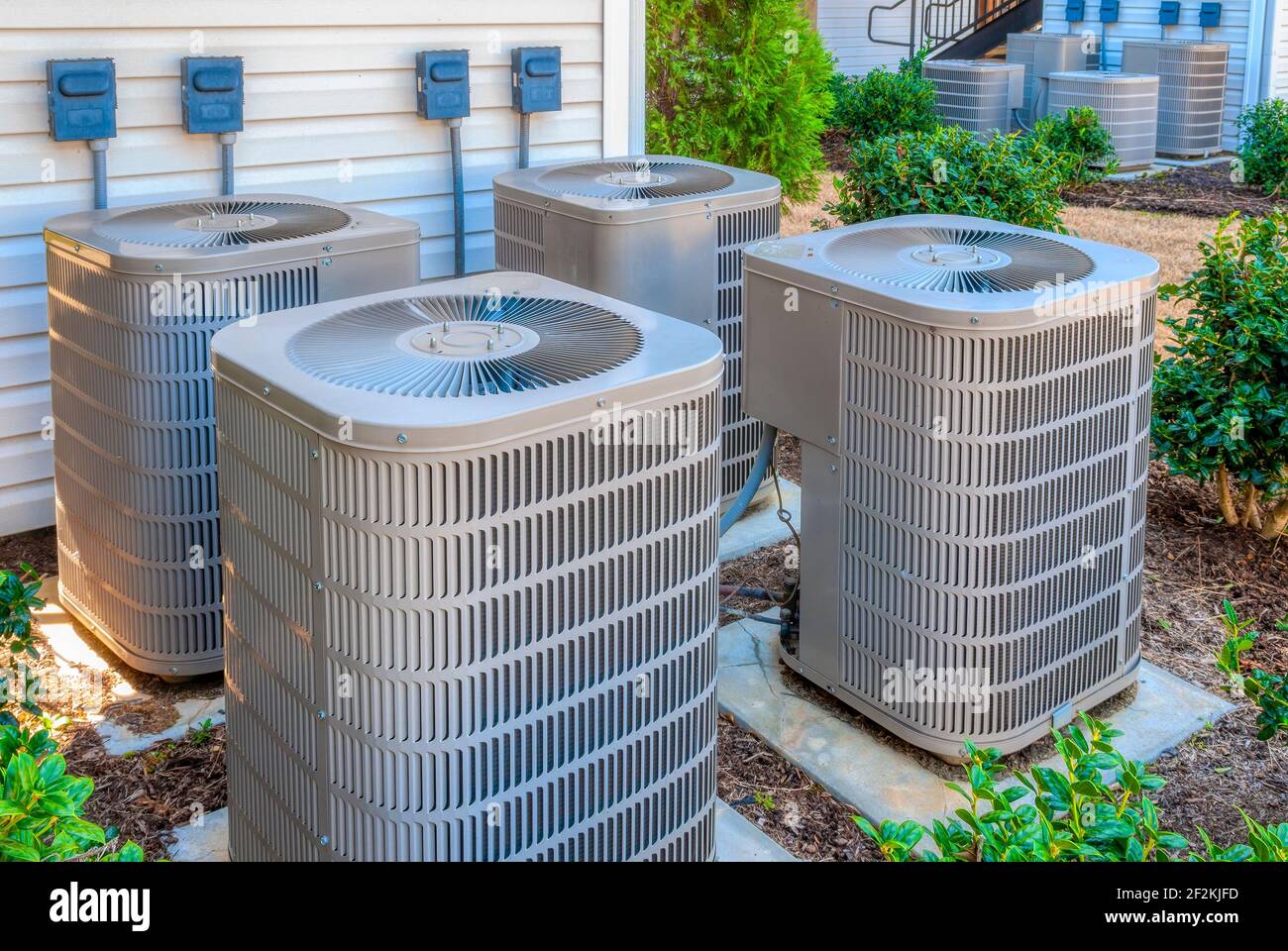 Horizontal shot of four air conditioning units outside of an upscale ...
