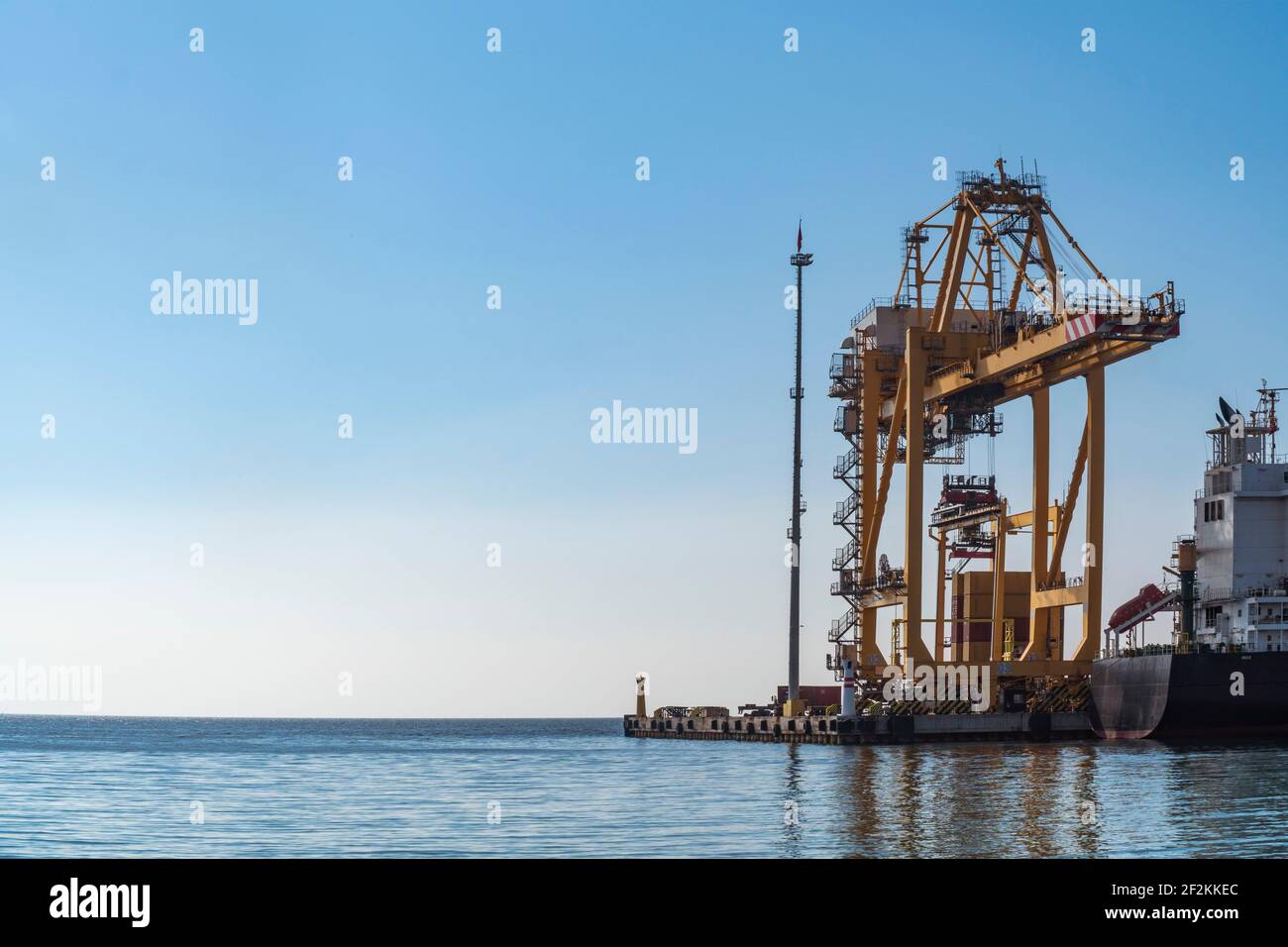 Worldwide shipping and cargo concept: View on yellow crane lift ...