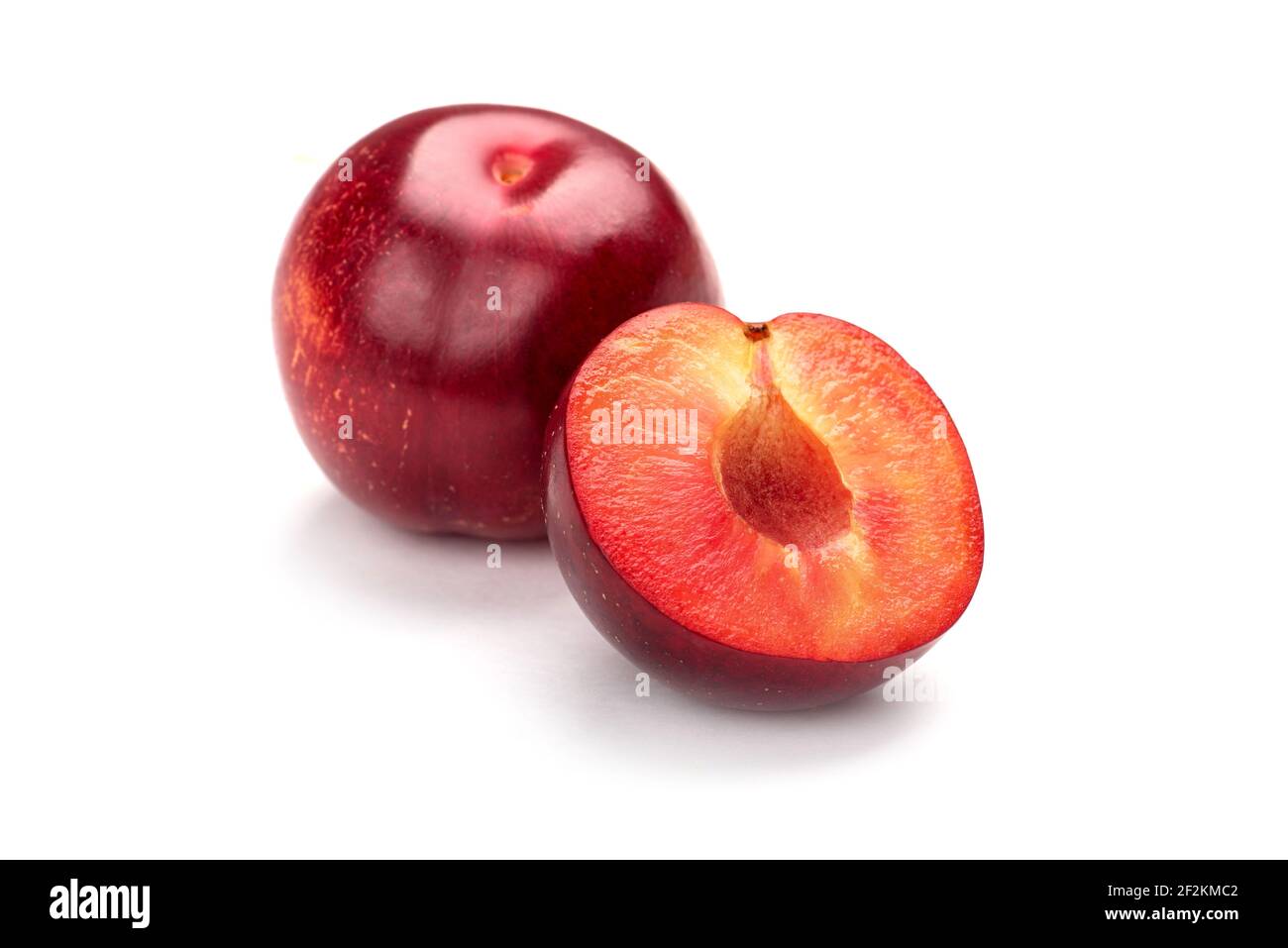 Cut fresh plums isolated on white background Stock Photo - Alamy