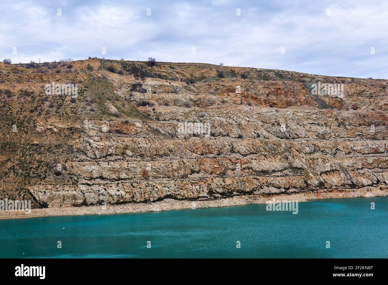 slopes of an old limestone quarry with a blue lake at the bottom Stock ...
