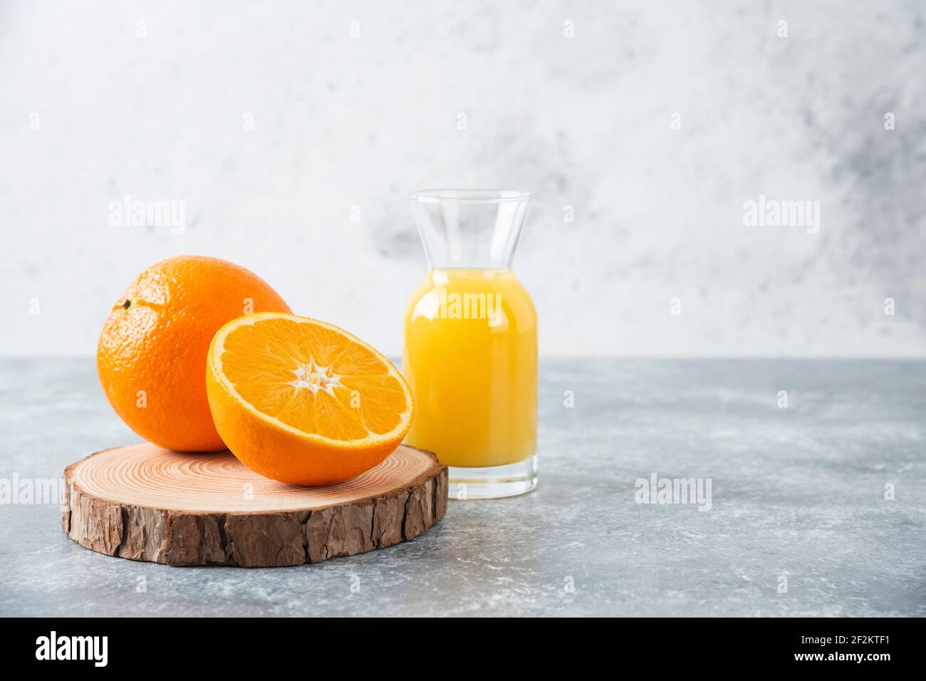 Glass pitcher of juice with sliced orange fruit on a wooden board Stock ...