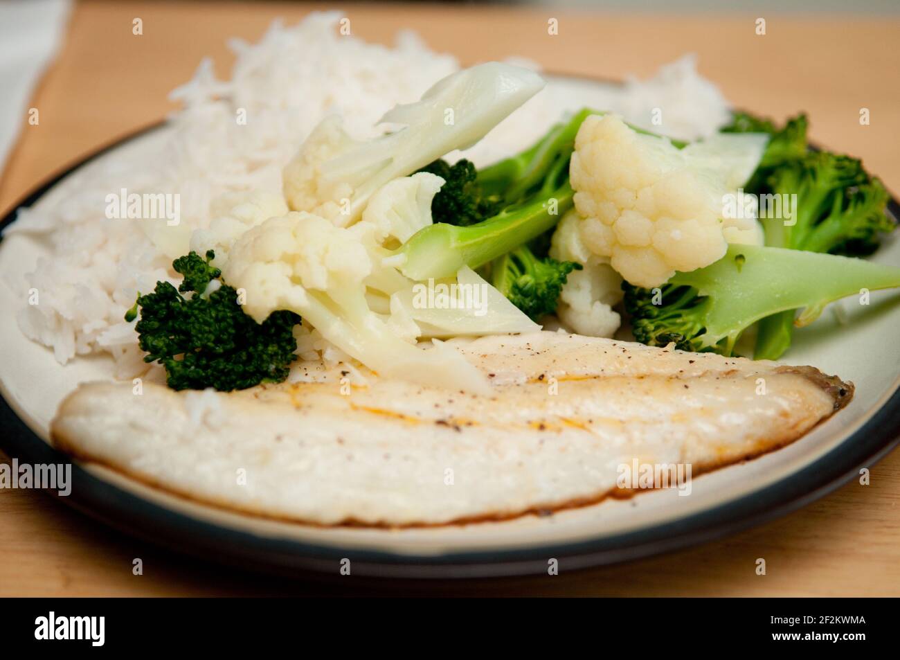 Roasted fish fillet served with cauliflower, broccoli, and rice Stock ...