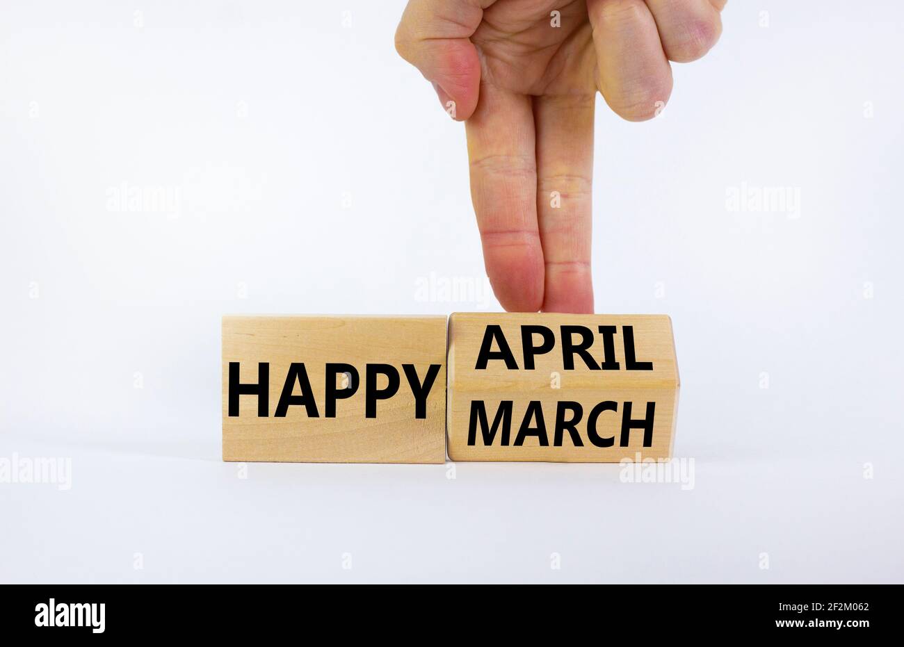 Symbol for the change from March to April. Businessman turns wooden ...