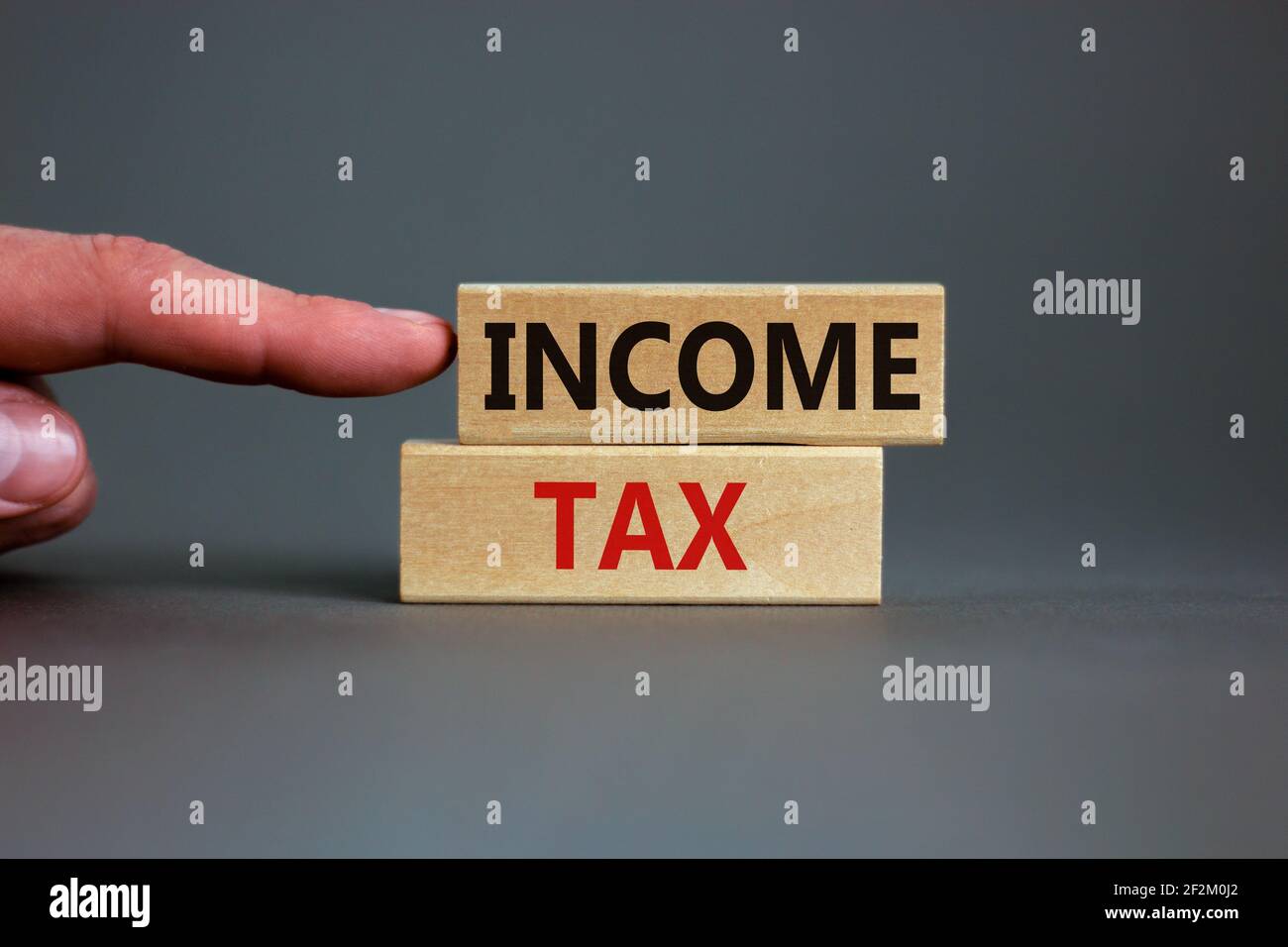 Income tax symbol. Concept words 'income tax' on wooden blocks on a ...