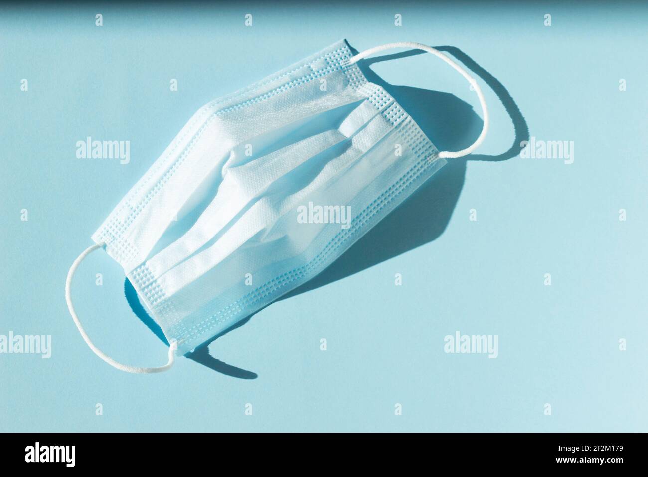 Protective medical mask on a blue background. Virus and flu protection ...