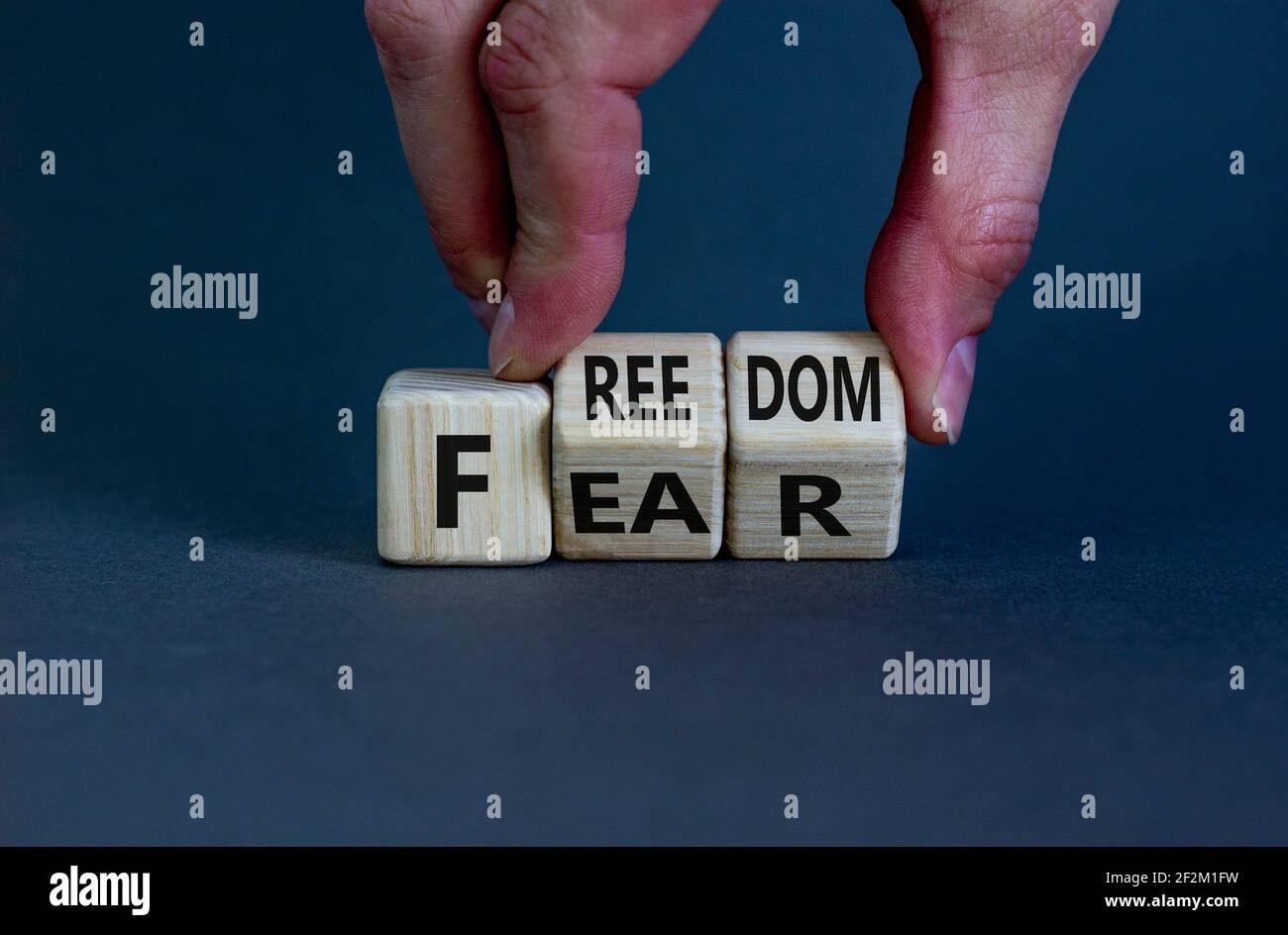 Freedom from fear symbol. Businessman turns wooden cubes and changes ...