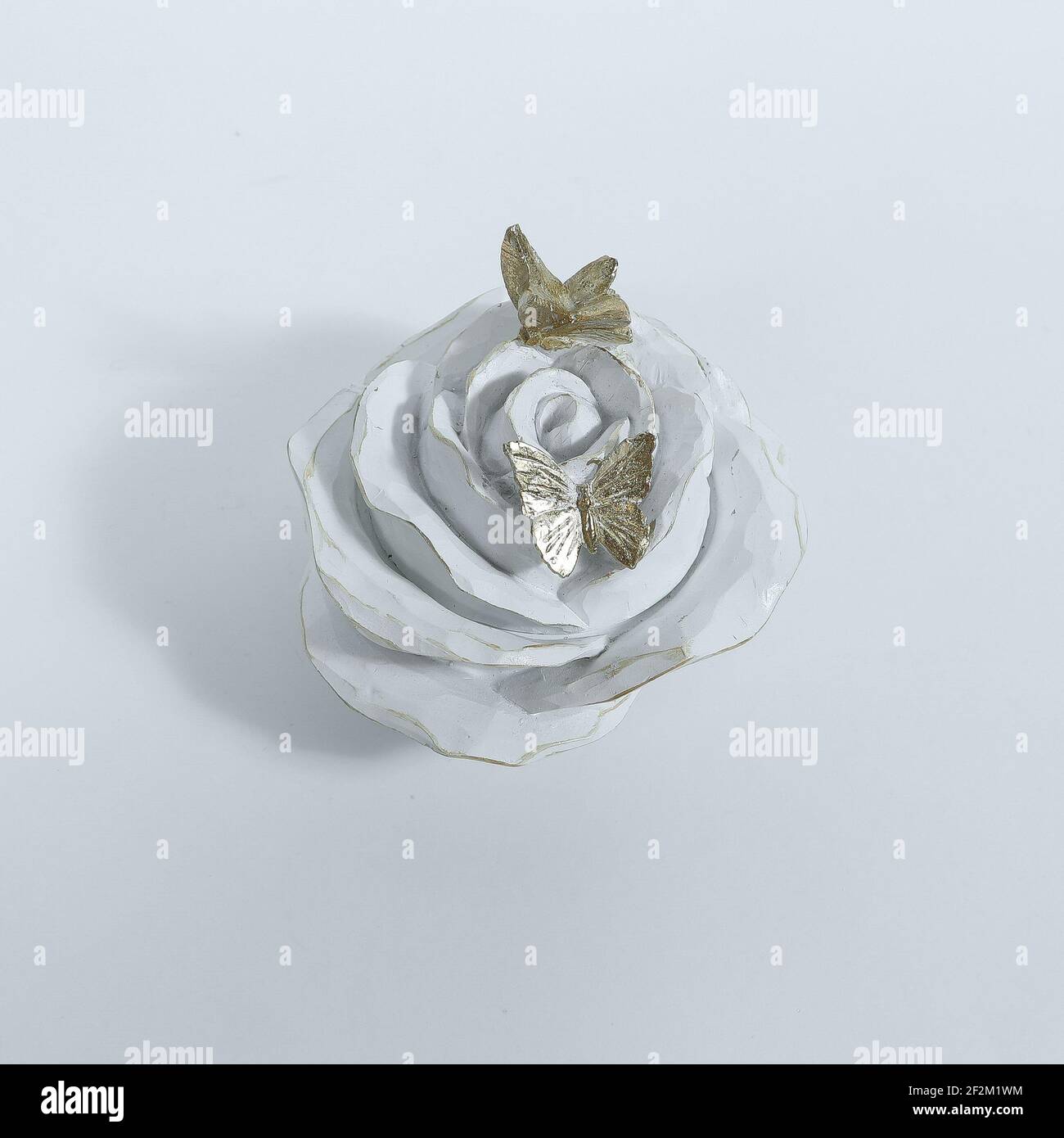 A closeup of rose and butterfly figures isolated on white background ...