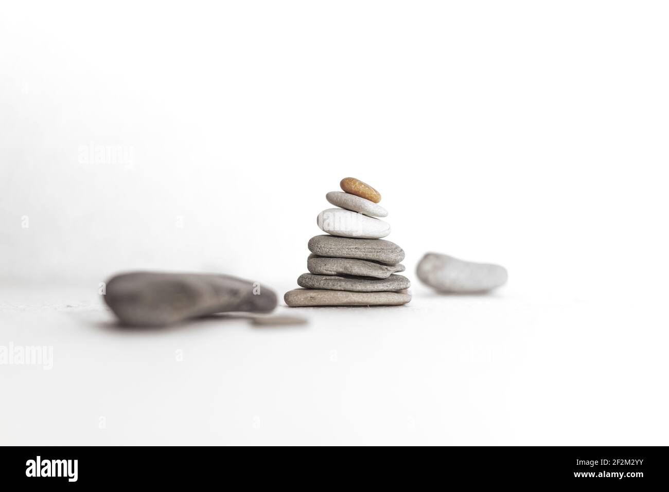 A closeup of stacked pebbles isolated on a white background - zen ...
